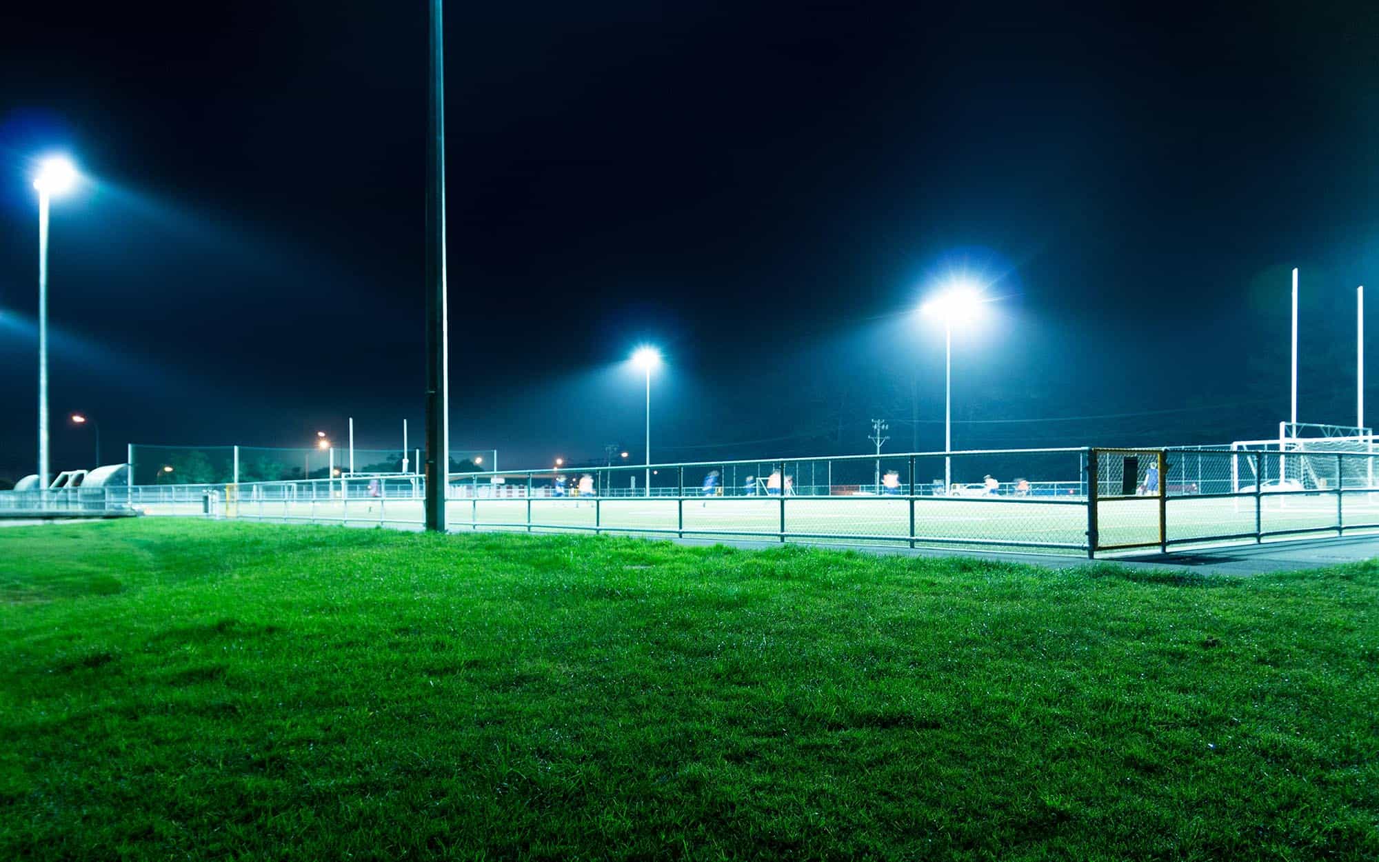Soccer field lit by lights at night - NGU Sports Lighting Soccer field lit by lights at night - NGU Sports Lighting